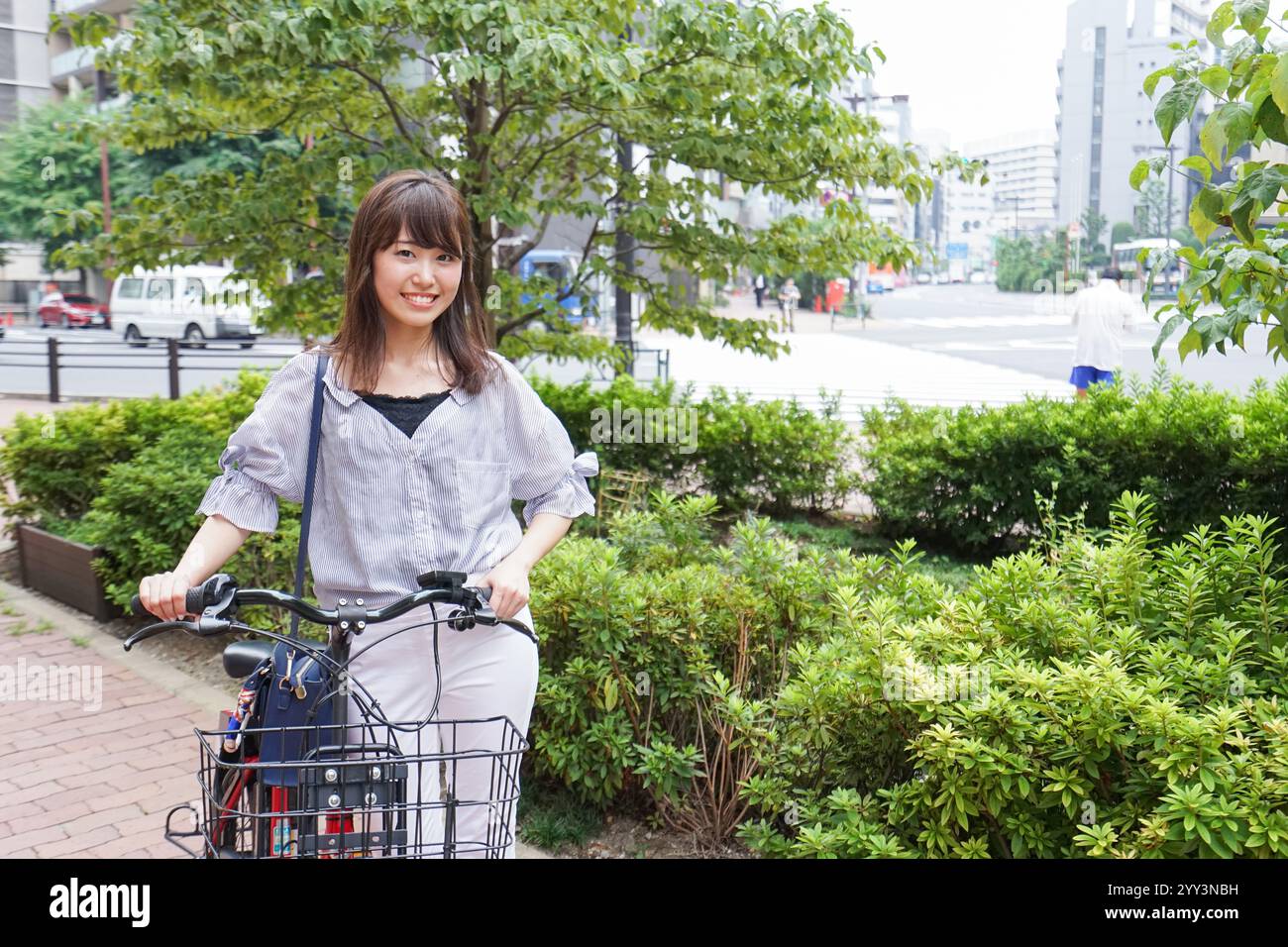 Woman pushing a bicycle Stock Photo - Alamy