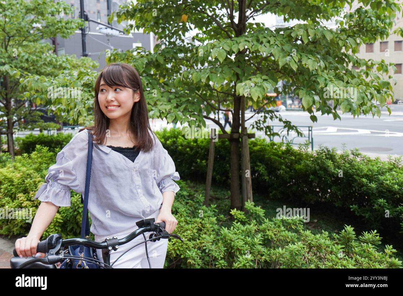 Girl pushing a bike hi-res stock photography and images - Alamy