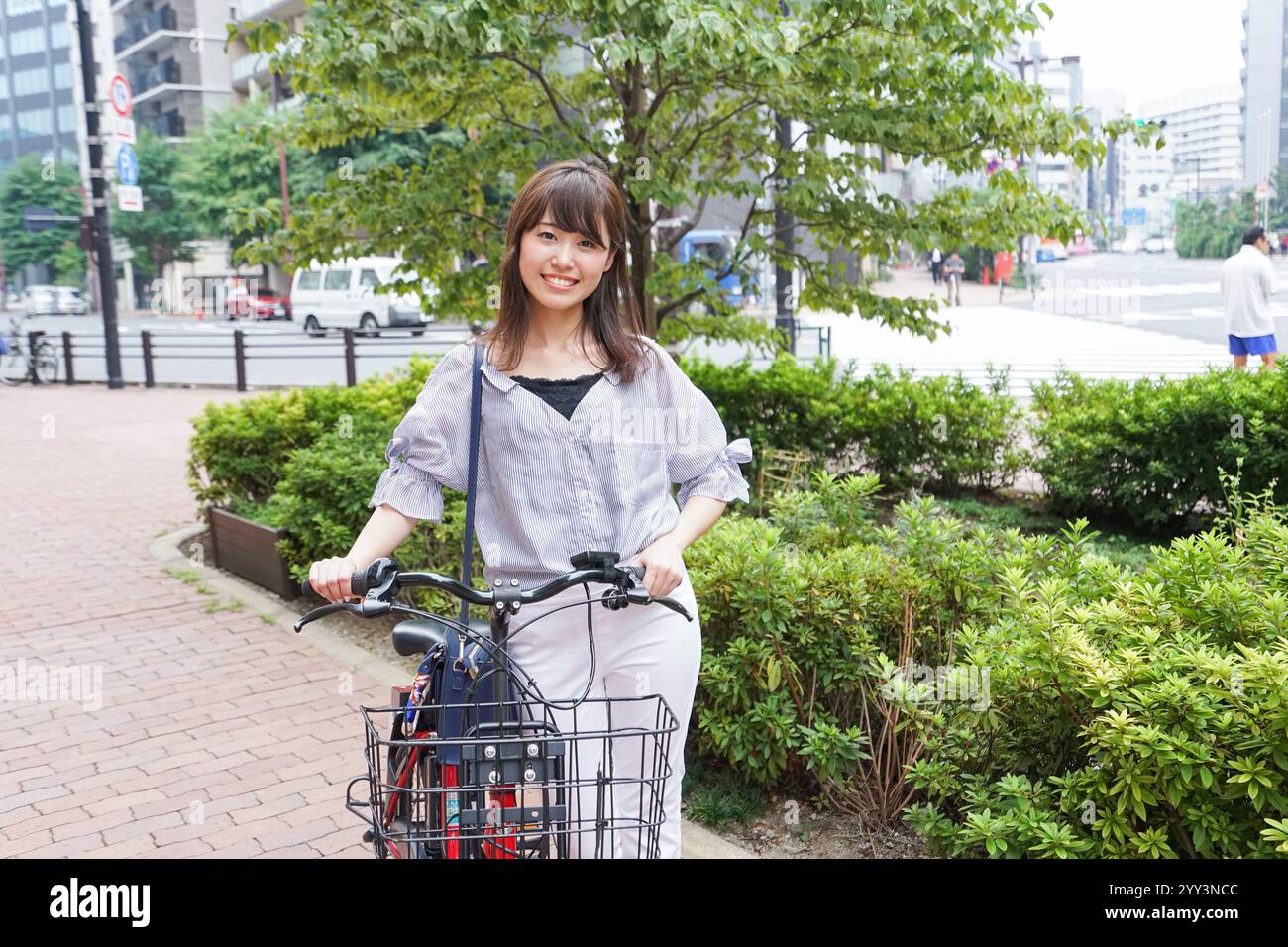 Girl pushing a bike hi-res stock photography and images - Alamy
