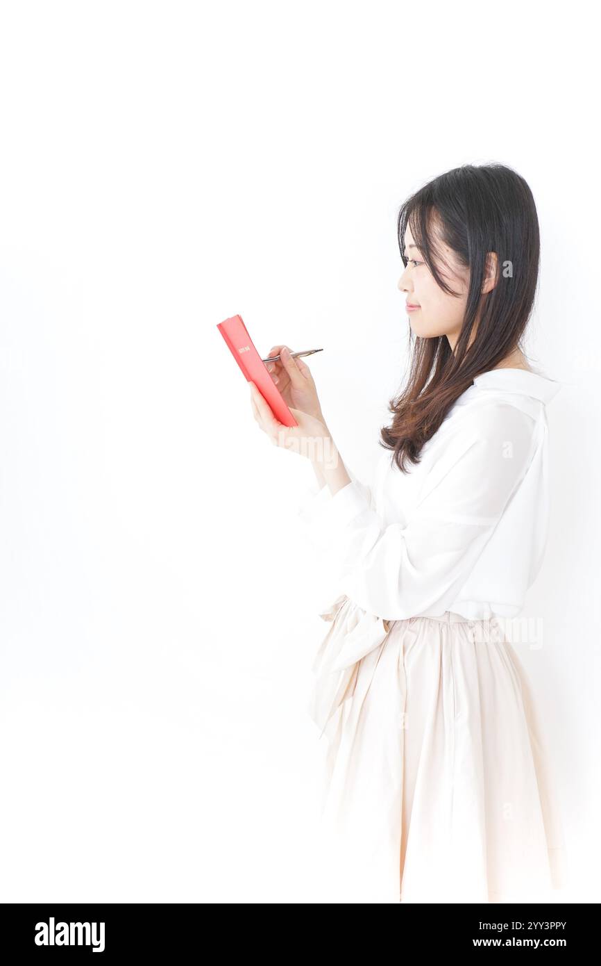 Woman taking notes Stock Photo - Alamy