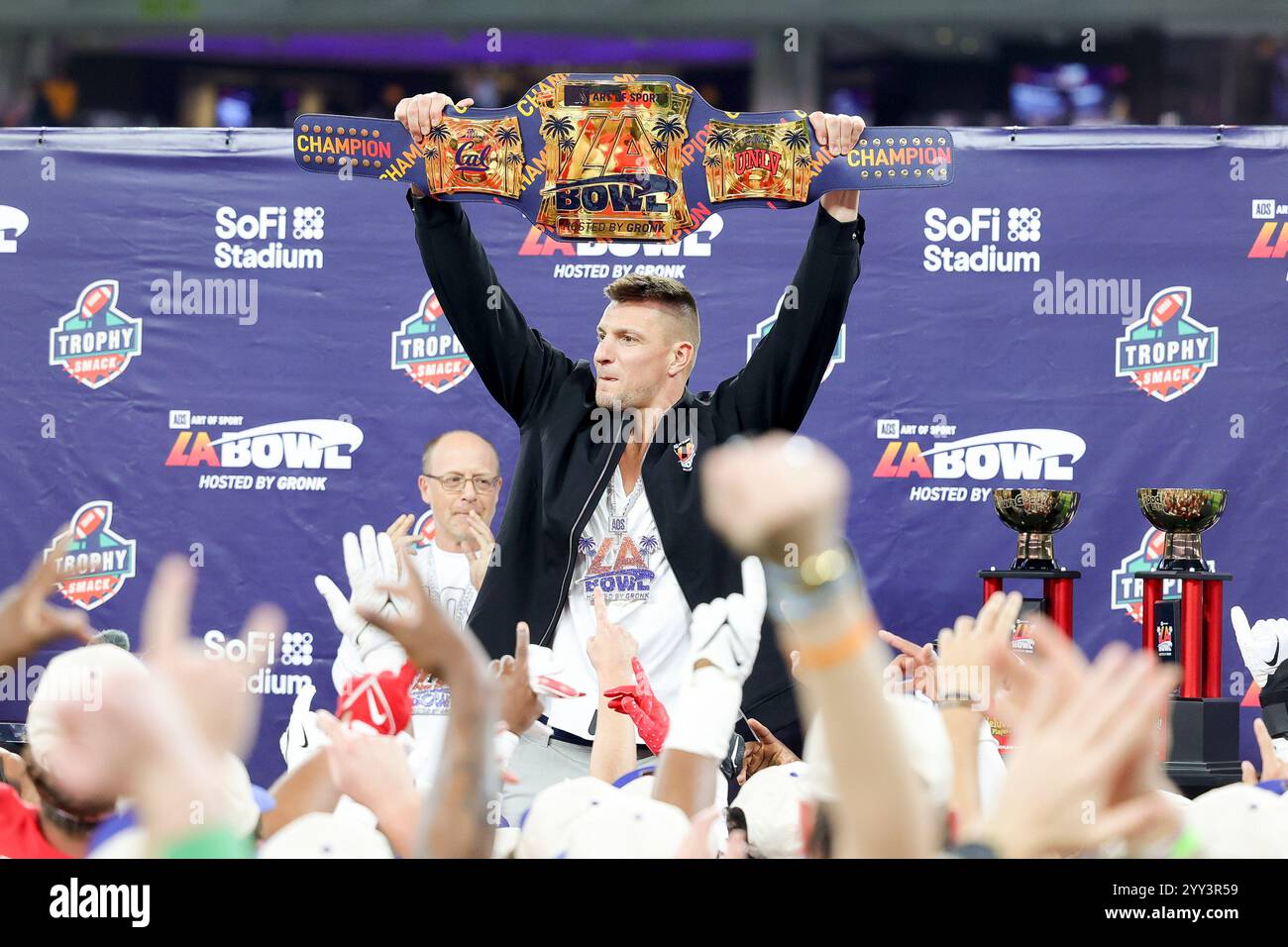 Former NFL tight end Rob Gronkowski holds up the LA Bowl belt after ...