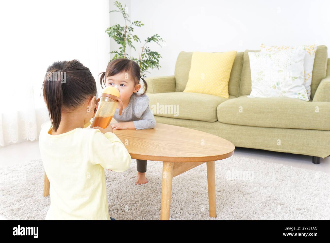Child taking care of younger sister Stock Photo - Alamy