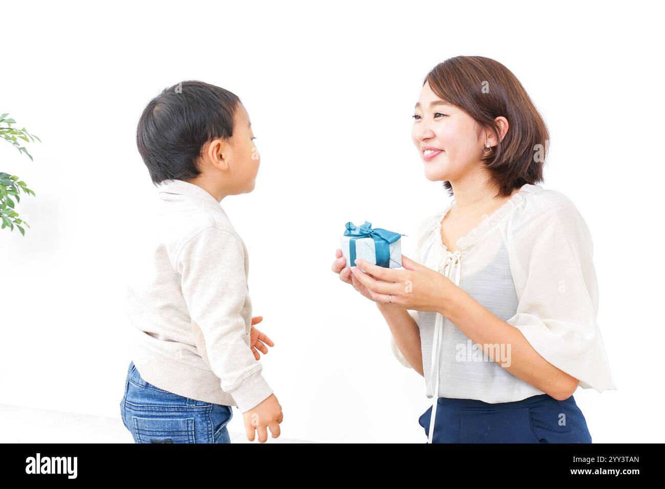 Child giving present to mother Stock Photo - Alamy