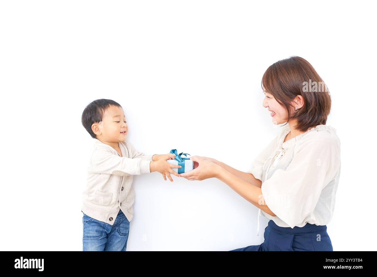 Child giving present to mother Stock Photo - Alamy