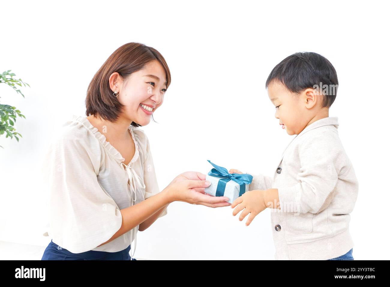 Child giving present to mother Stock Photo - Alamy