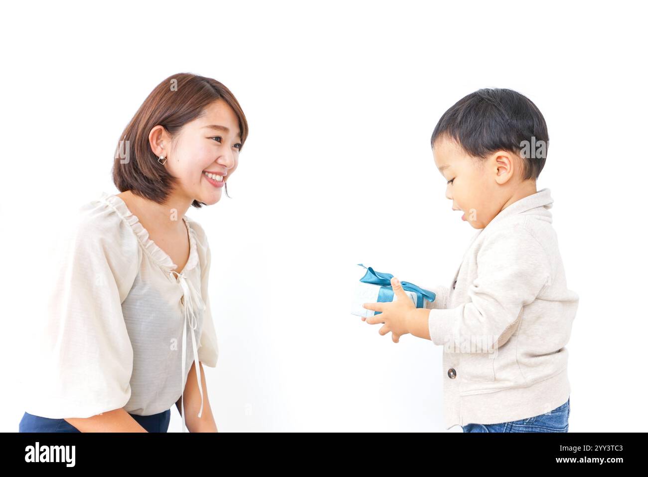 Child giving present to mother Stock Photo - Alamy