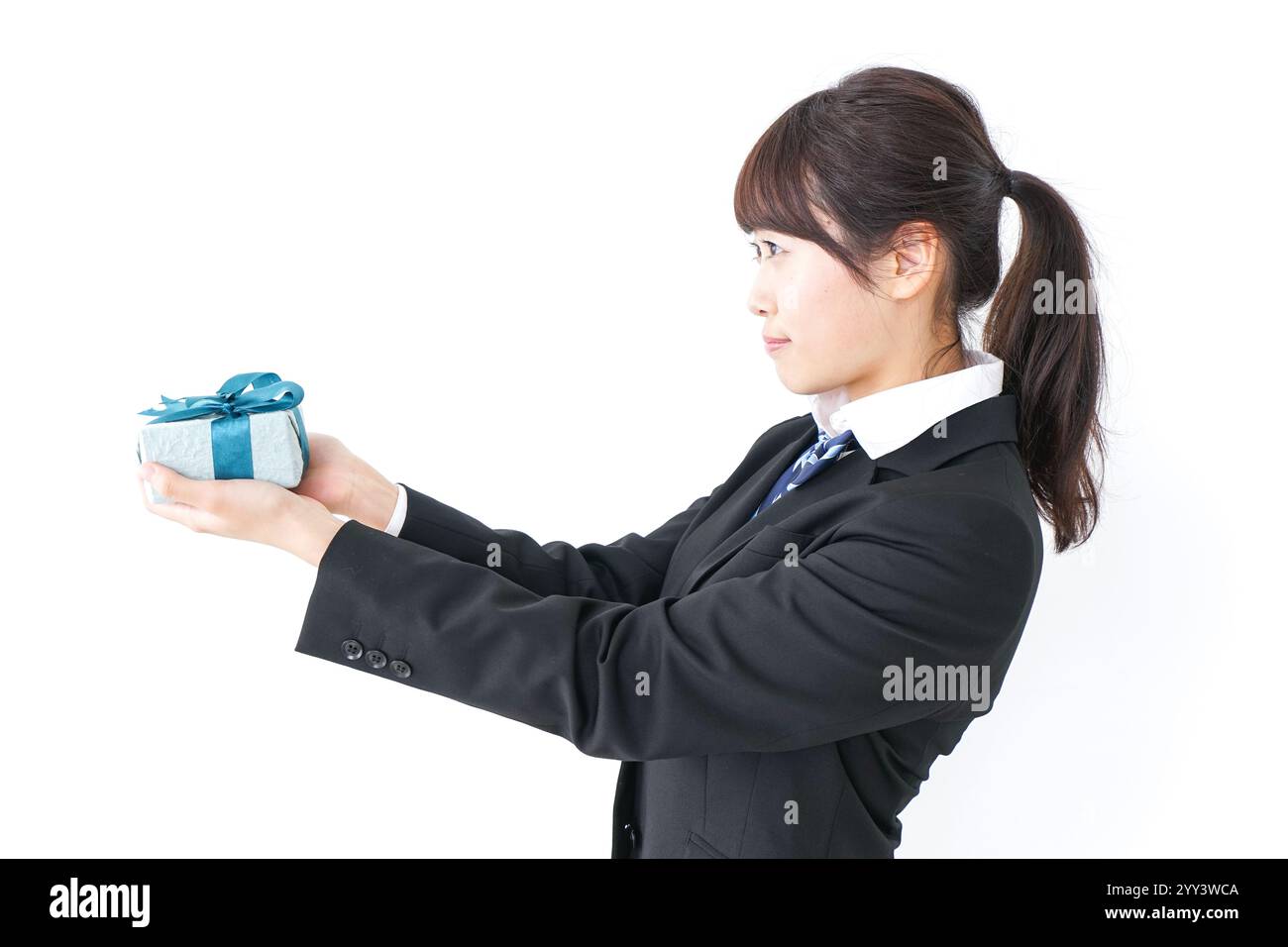 High school girl giving a present Stock Photo - Alamy