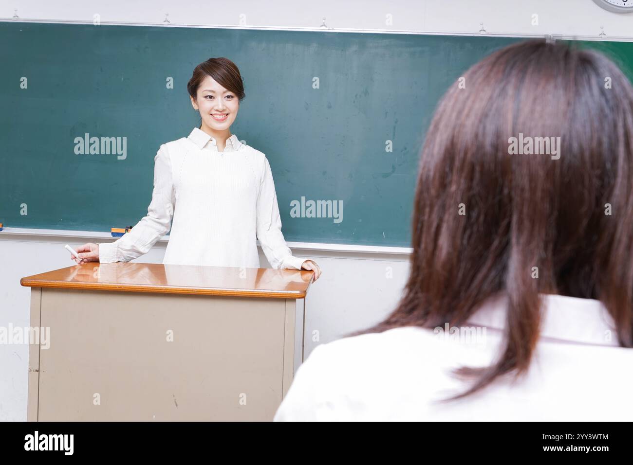 Teacher giving a lesson at school Stock Photo - Alamy