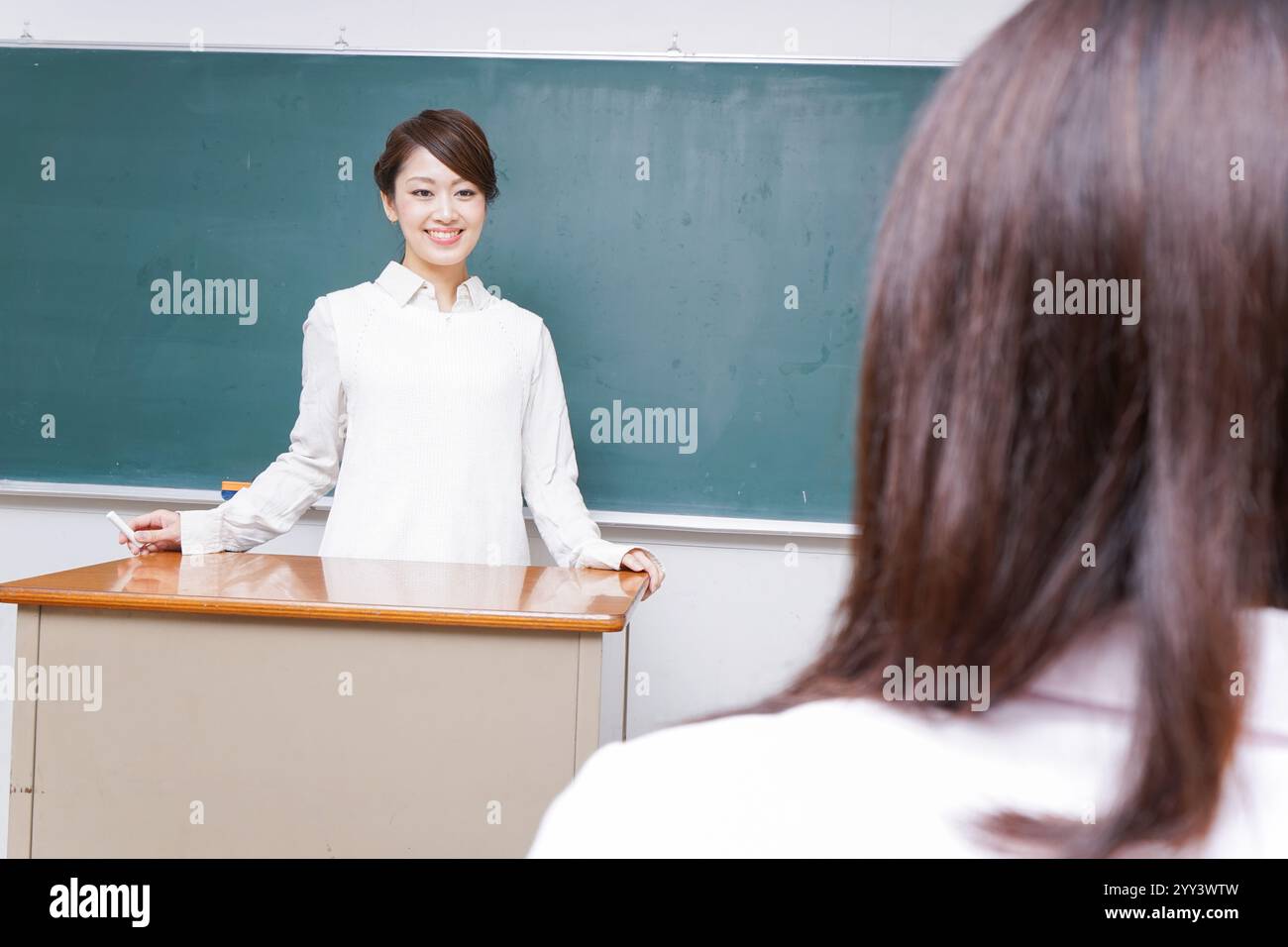 Teacher giving a lesson at school Stock Photo - Alamy