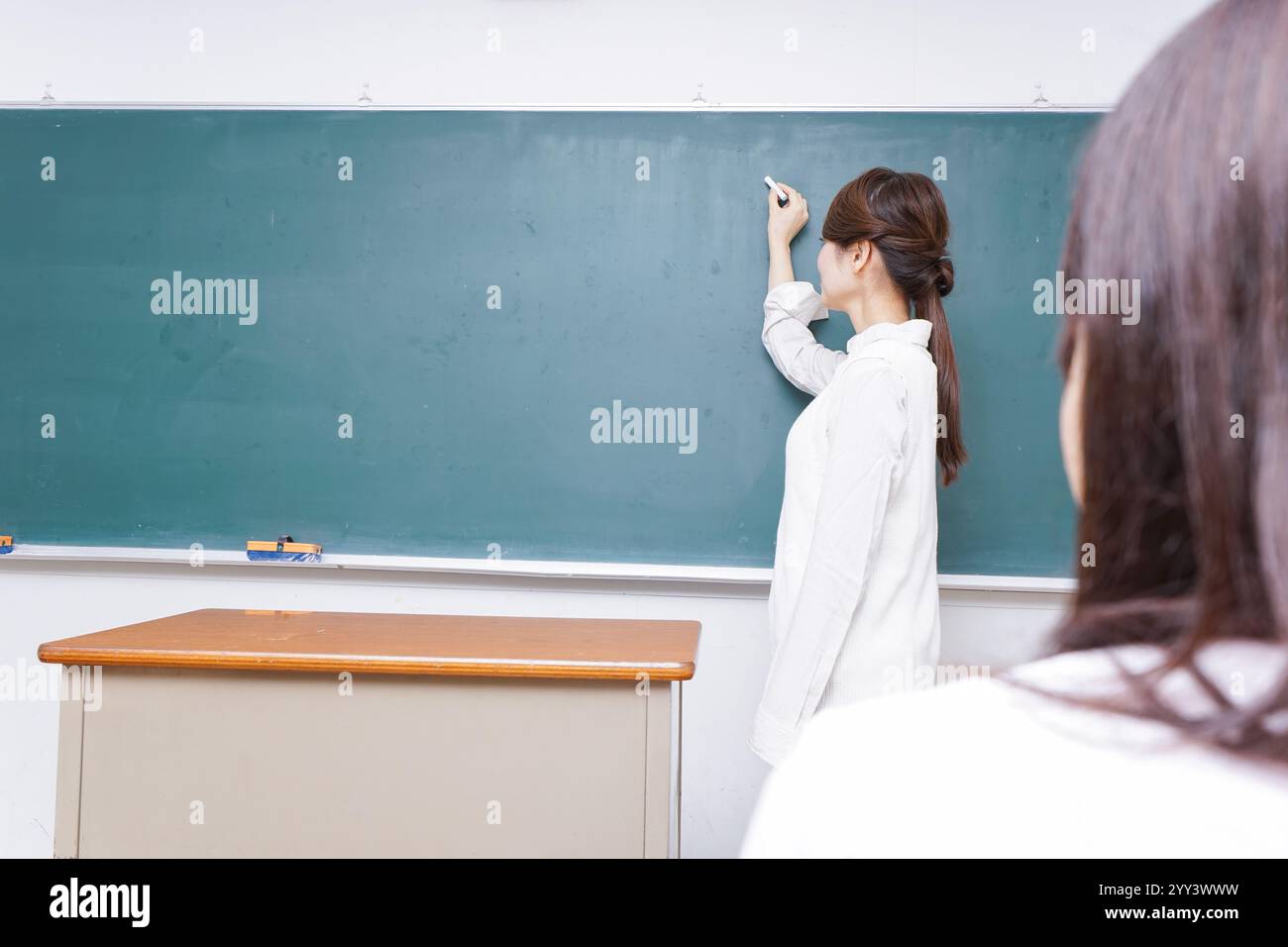 Teacher giving a lesson at school Stock Photo - Alamy