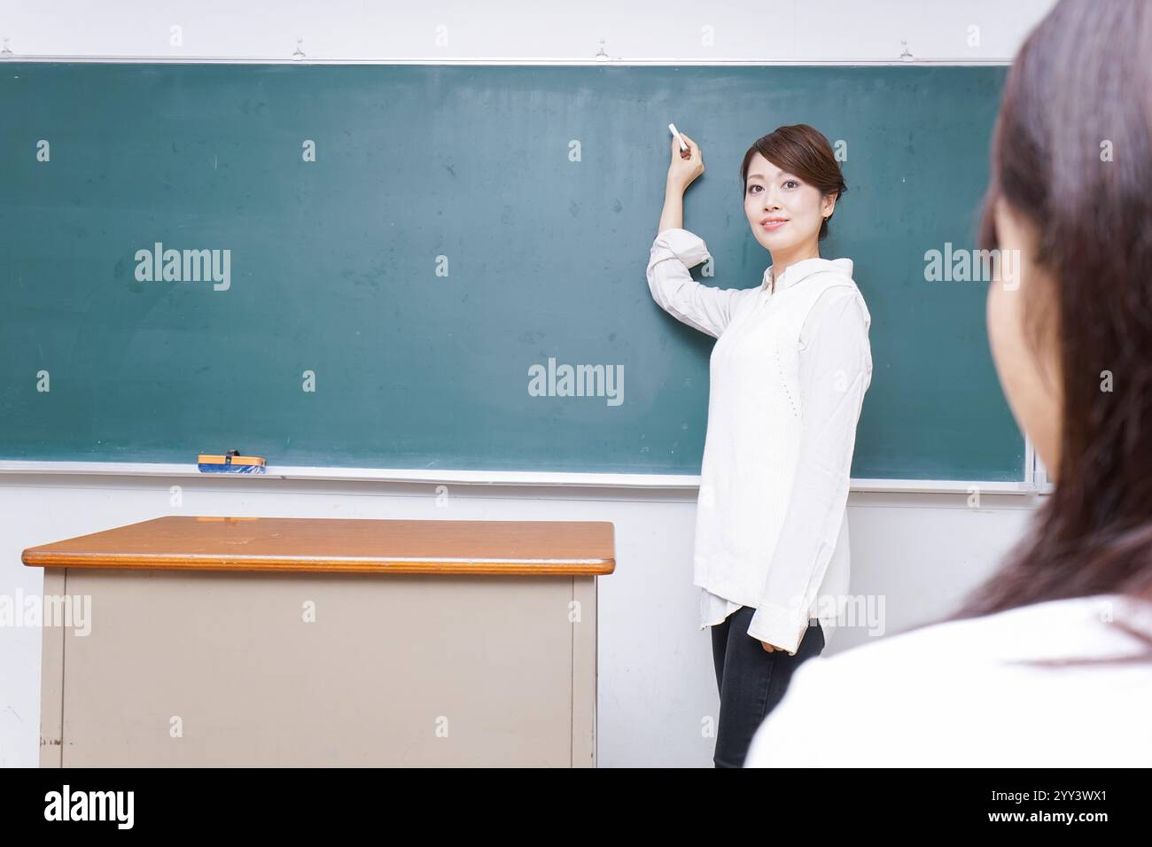 Teacher giving a lesson at school Stock Photo - Alamy
