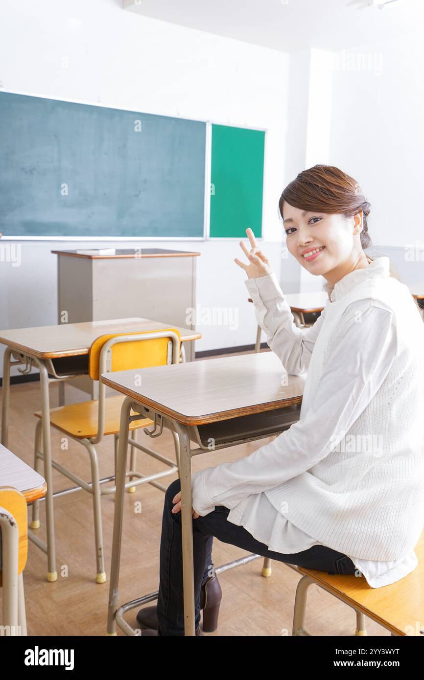 Student pointing fingers in classroom Stock Photo - Alamy