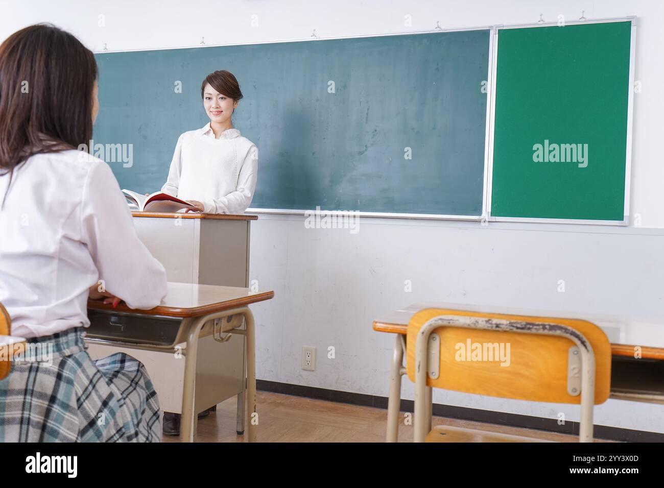 Teacher giving a lesson at school Stock Photo - Alamy