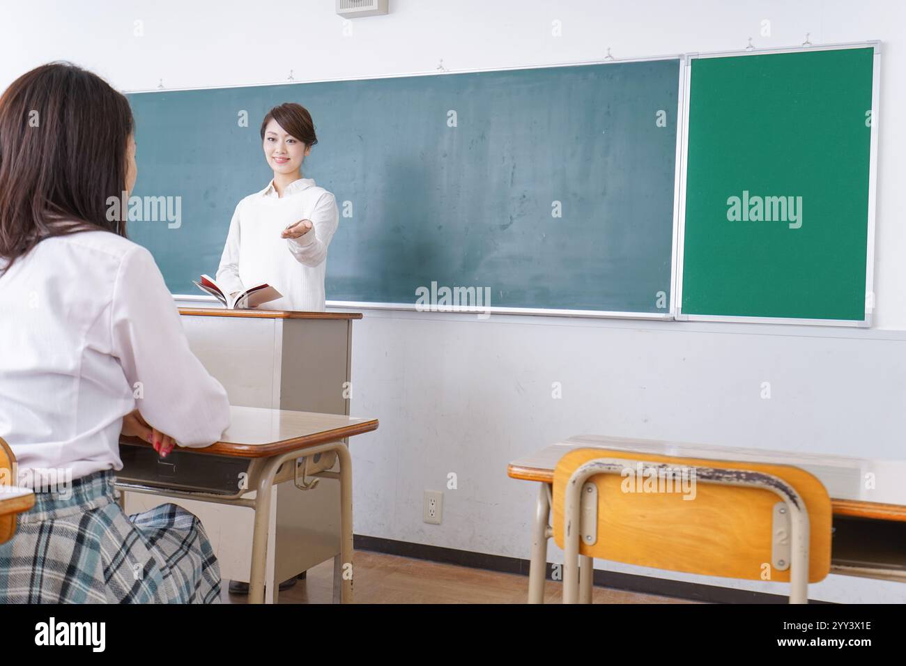 Teacher giving a lesson at school Stock Photo - Alamy