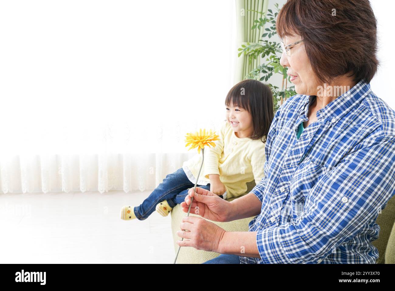 Child giving flowers to grandmother Stock Photo - Alamy