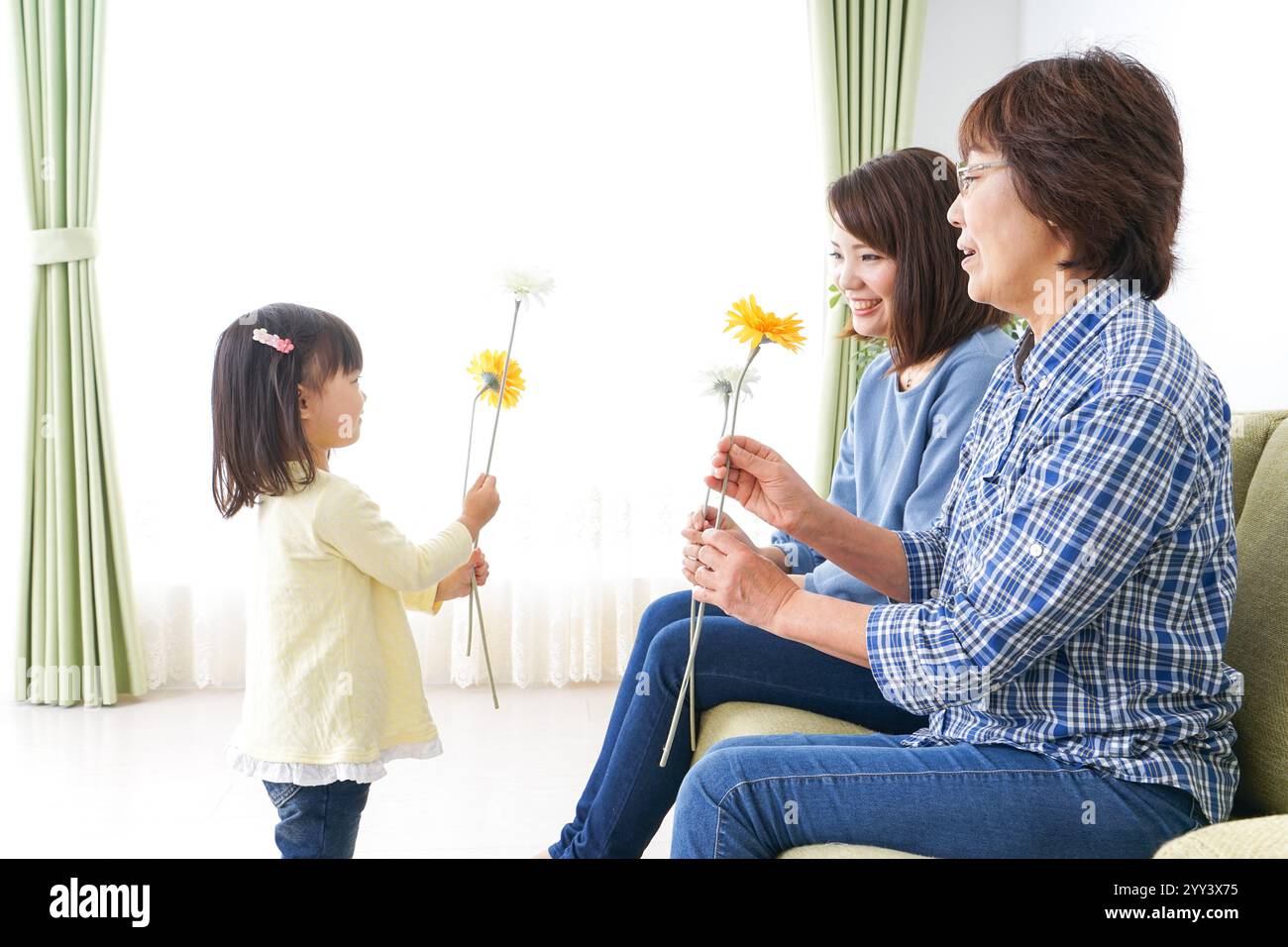 Child giving flowers to grandmother Stock Photo - Alamy