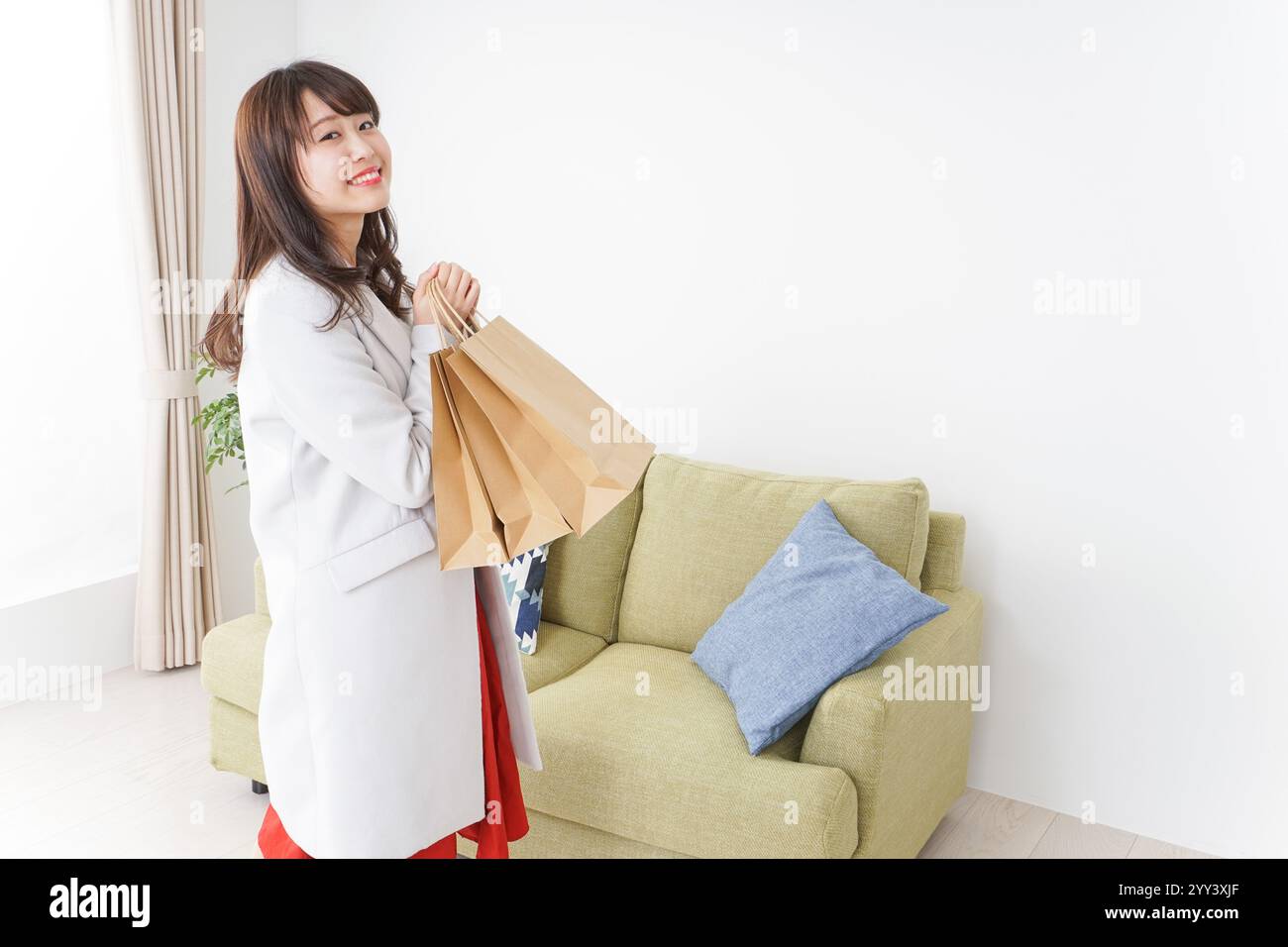 Woman returning from shopping Stock Photo - Alamy