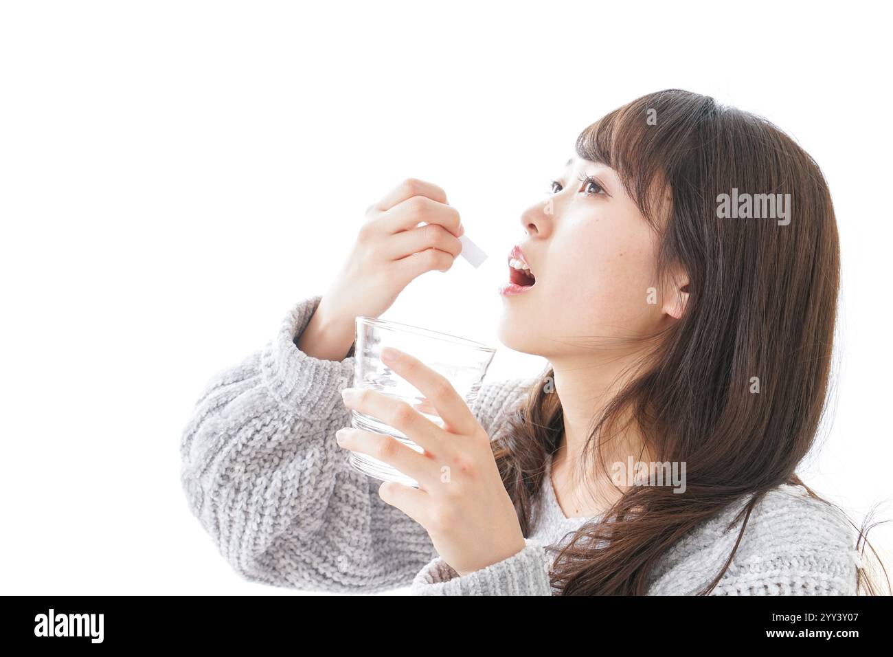 Woman taking powder medicine Stock Photo - Alamy