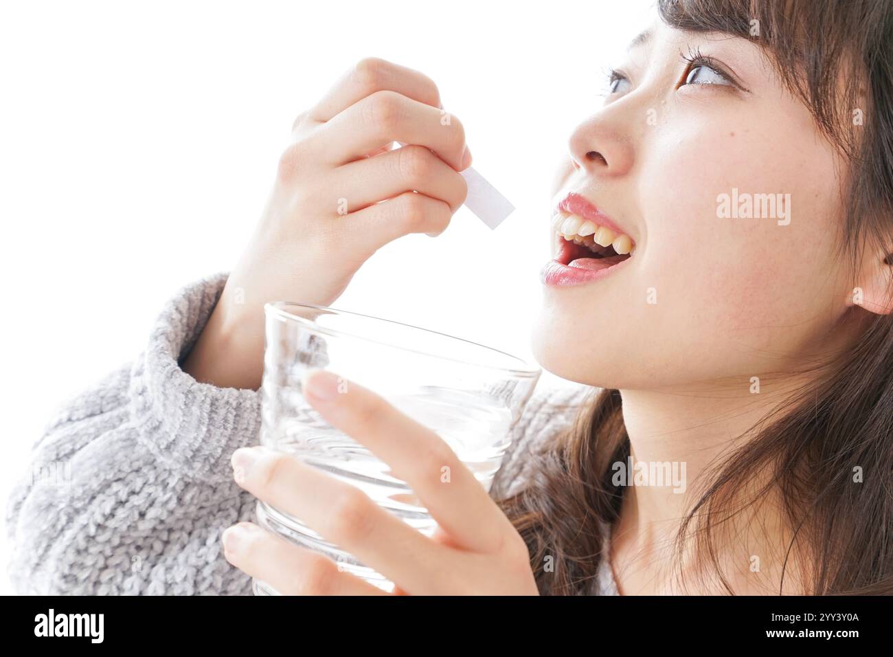 Woman taking powder medicine Stock Photo - Alamy
