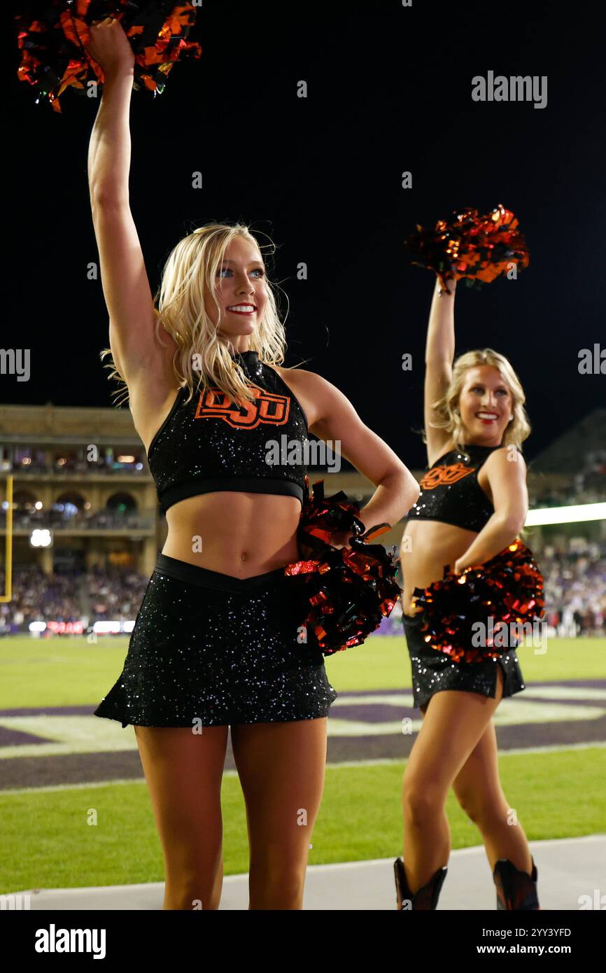 Oklahoma State spirit team members cheer during an NCAA college ...