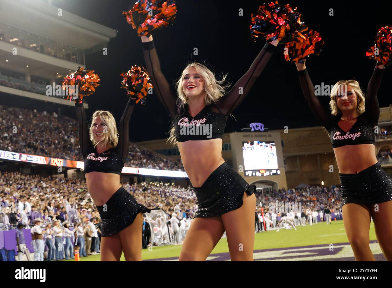 Oklahoma State spirit team members cheer during an NCAA college ...