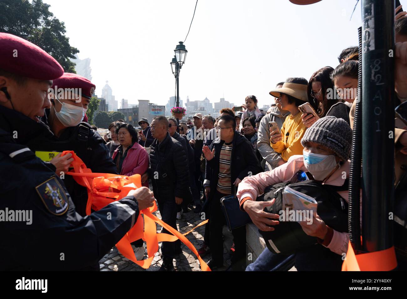 Visitors gather as police officers cordon off the Macao Museum near the ...