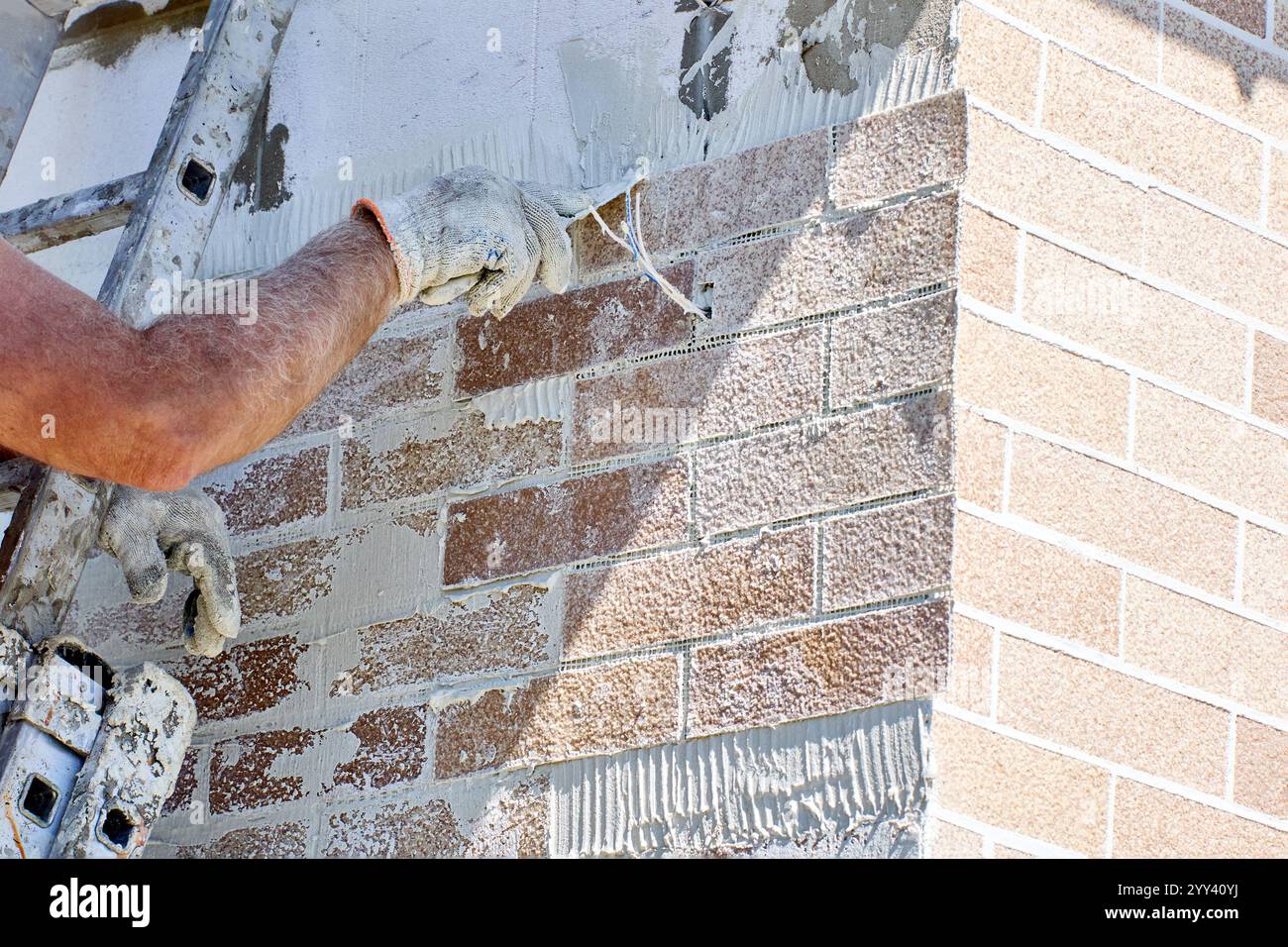 Facade with decorative brick cladding made of marble chips with acrylic ...