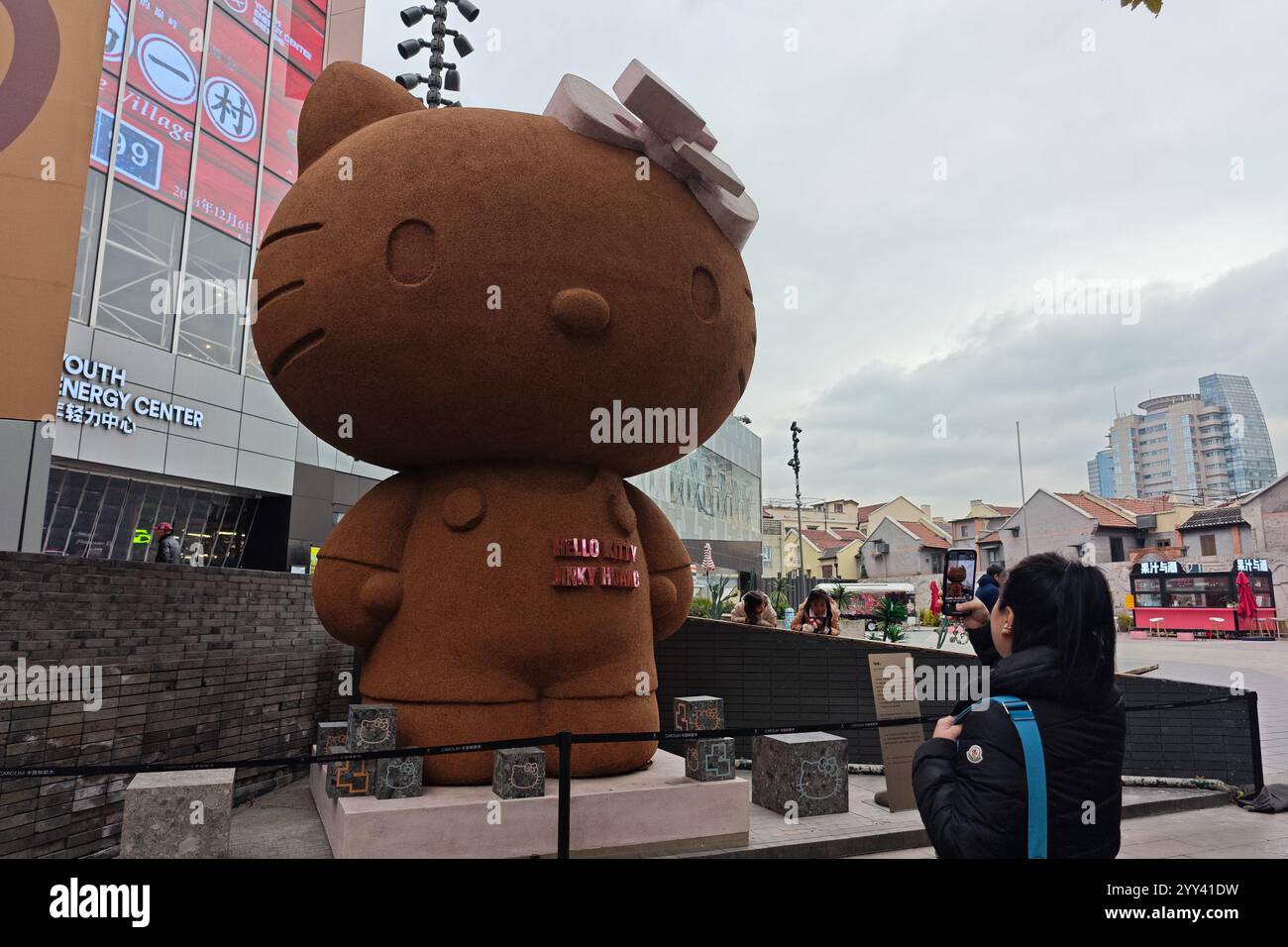 SHANGHAI, CHINA - DECEMBER 19, 2024 - Pedestrians walk past a giant ...