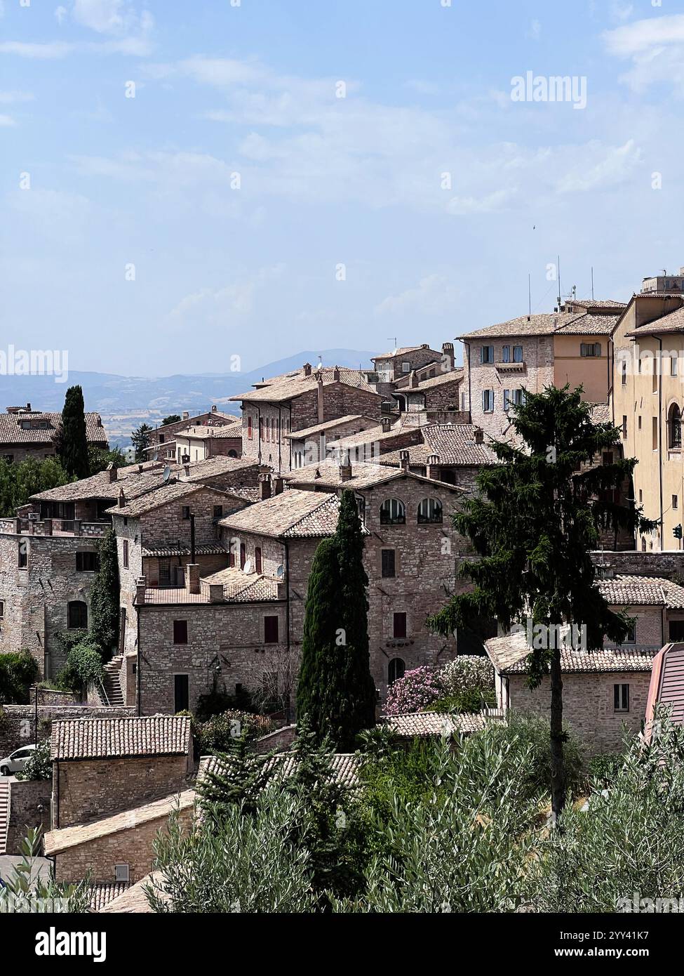 Italian village featuring rustic stone houses and lush greenery under a ...