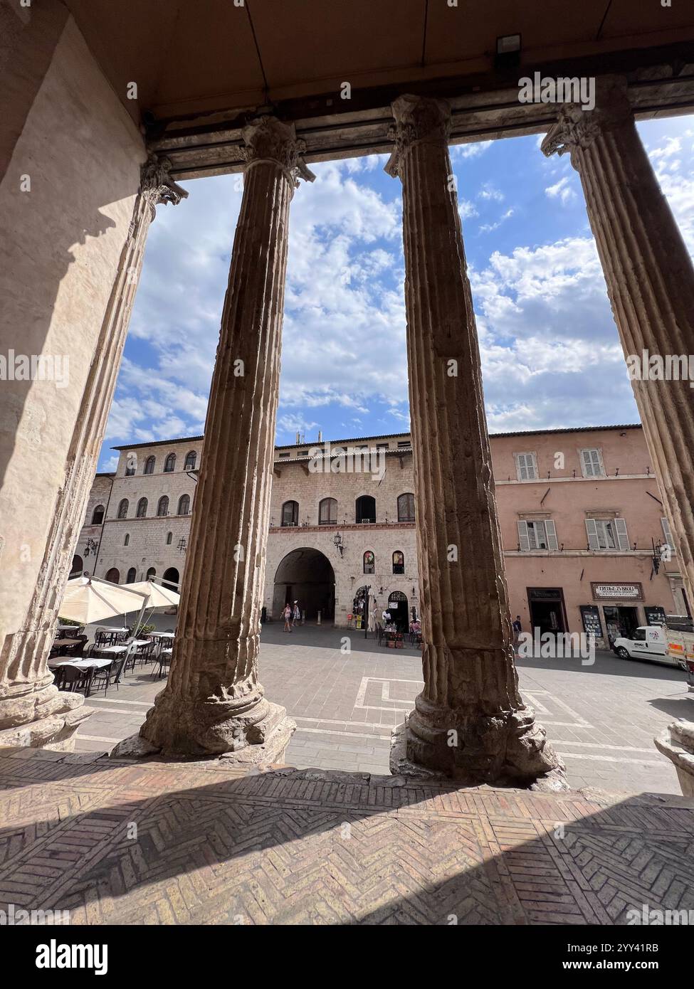 View of ancient Roman columns with a bustling town square and a vivid ...