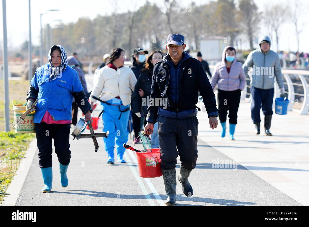 People go beachcombing at seaside in Qingdao City, east China's ...
