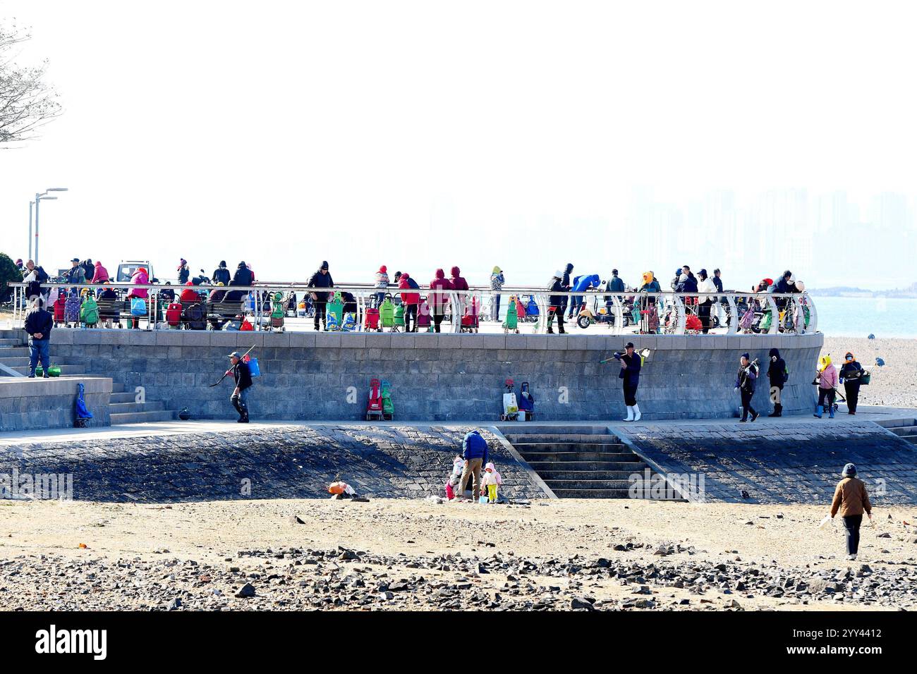 People go beachcombing at seaside in Qingdao City, east China's ...