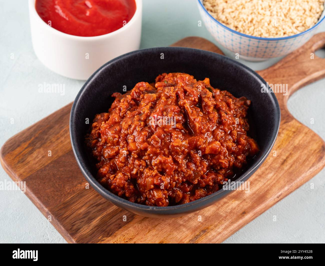 Vegan tomato bolognese ragu with soya protein granules in bowl Stock ...