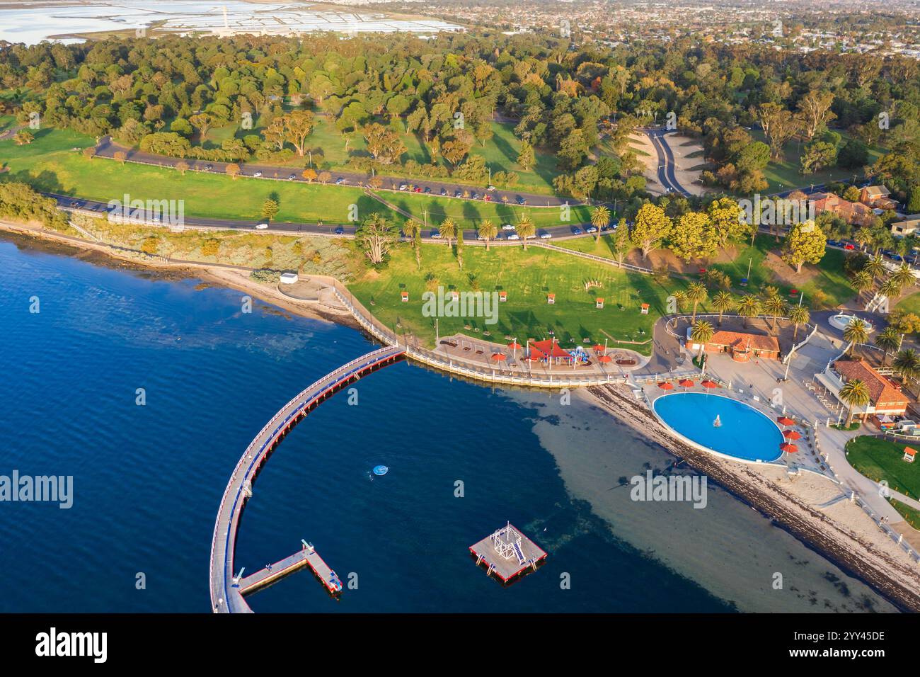 Aerial view of a swimming enclosure and parkland along a coastal city ...