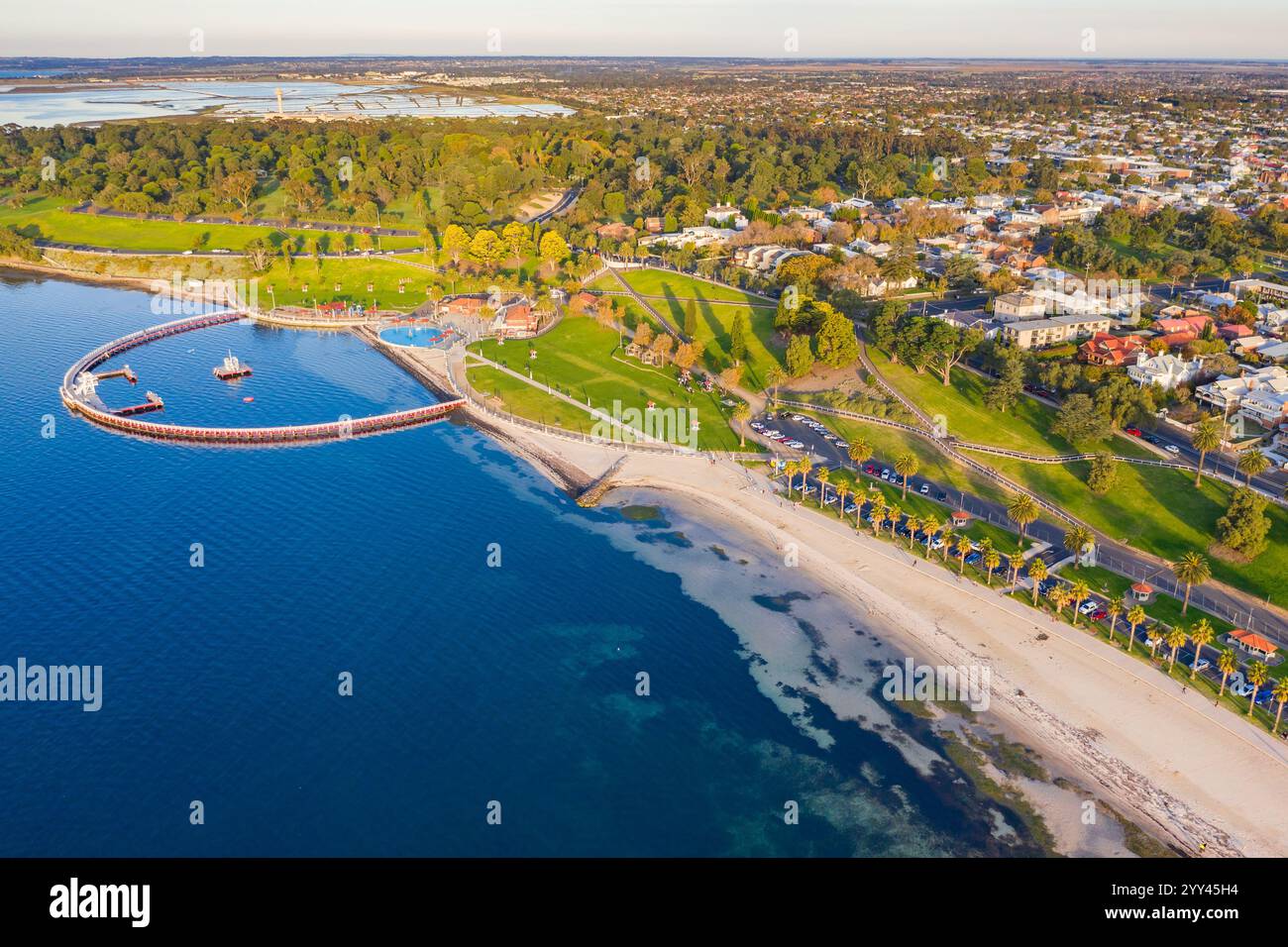 Aerial view of a swimming enclosure and parkland along a coastal city ...