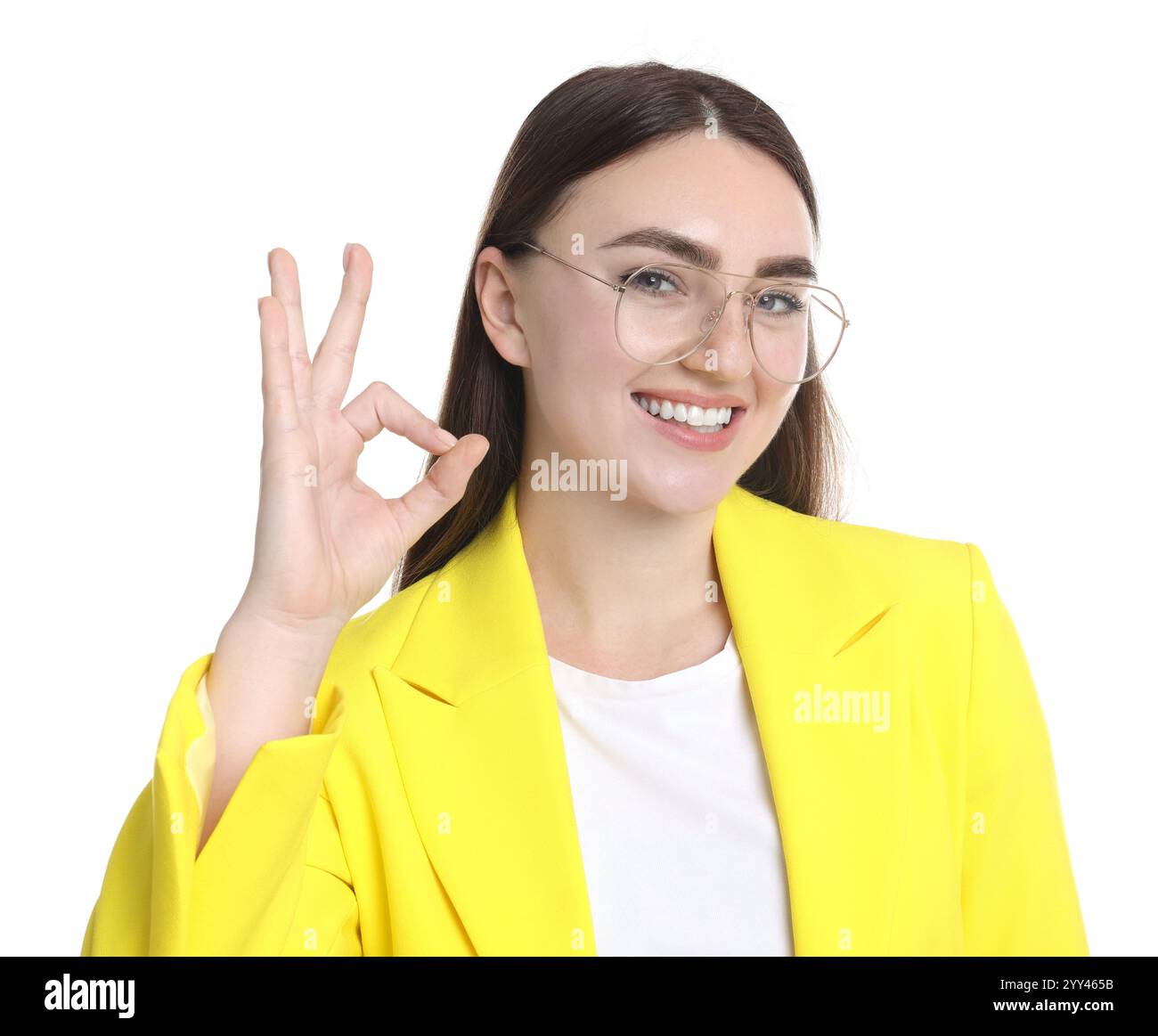Happy young woman showing OK gesture on white background Stock Photo ...