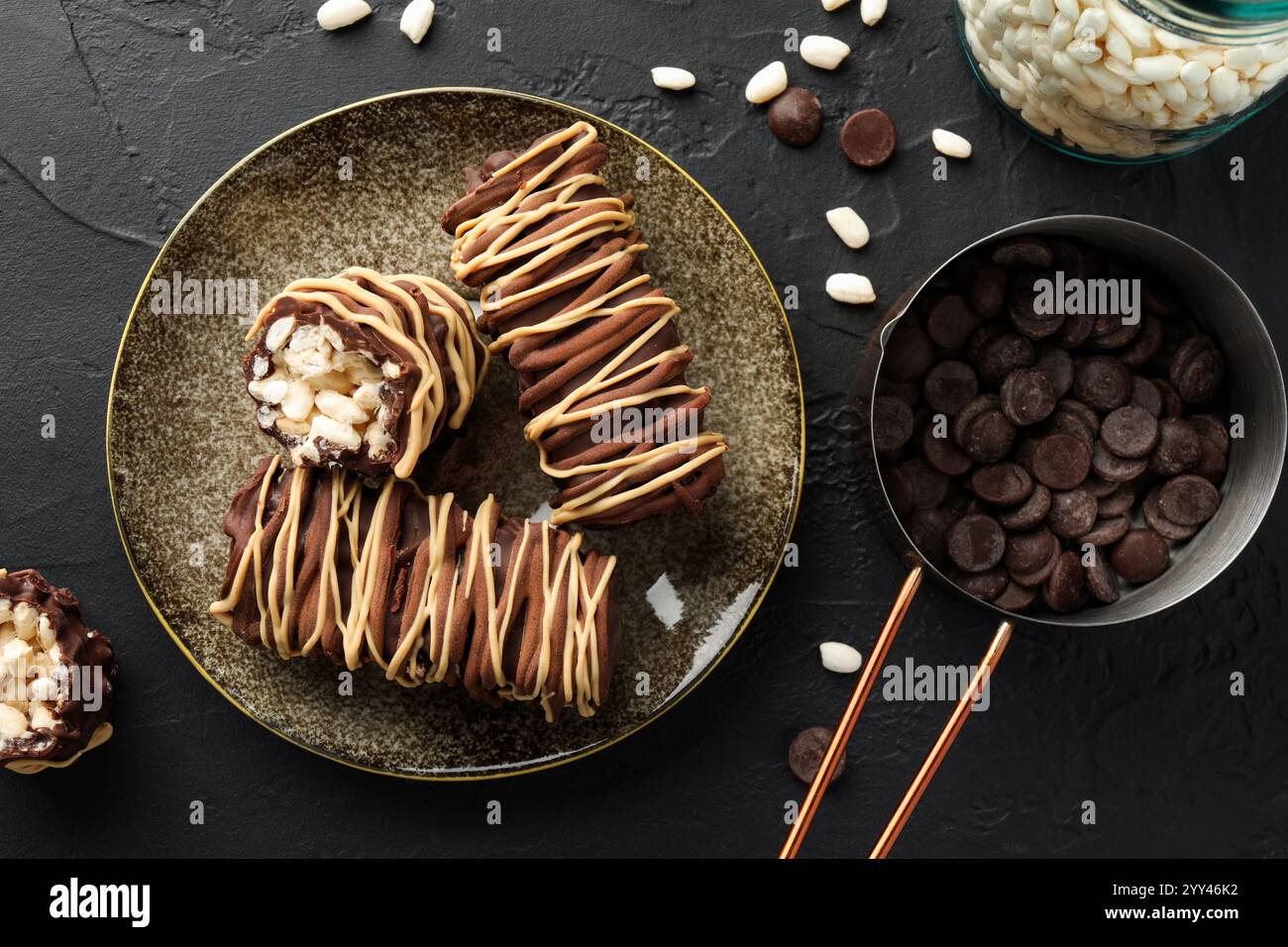 Delicious chocolate puffed rice bars and ingredients on dark gray ...