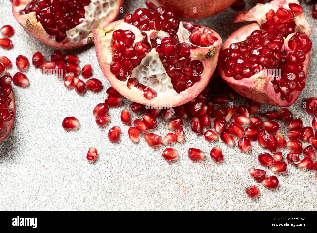 Pomegranate Seeds and Pomegranates on a Stone Gray Background Close-up ...