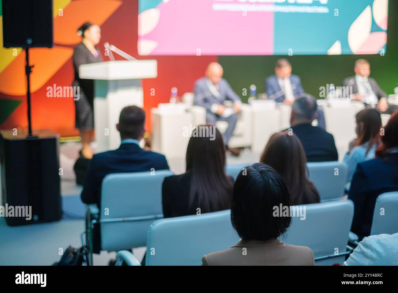 Professional business event featuring speakers on stage, audience ...