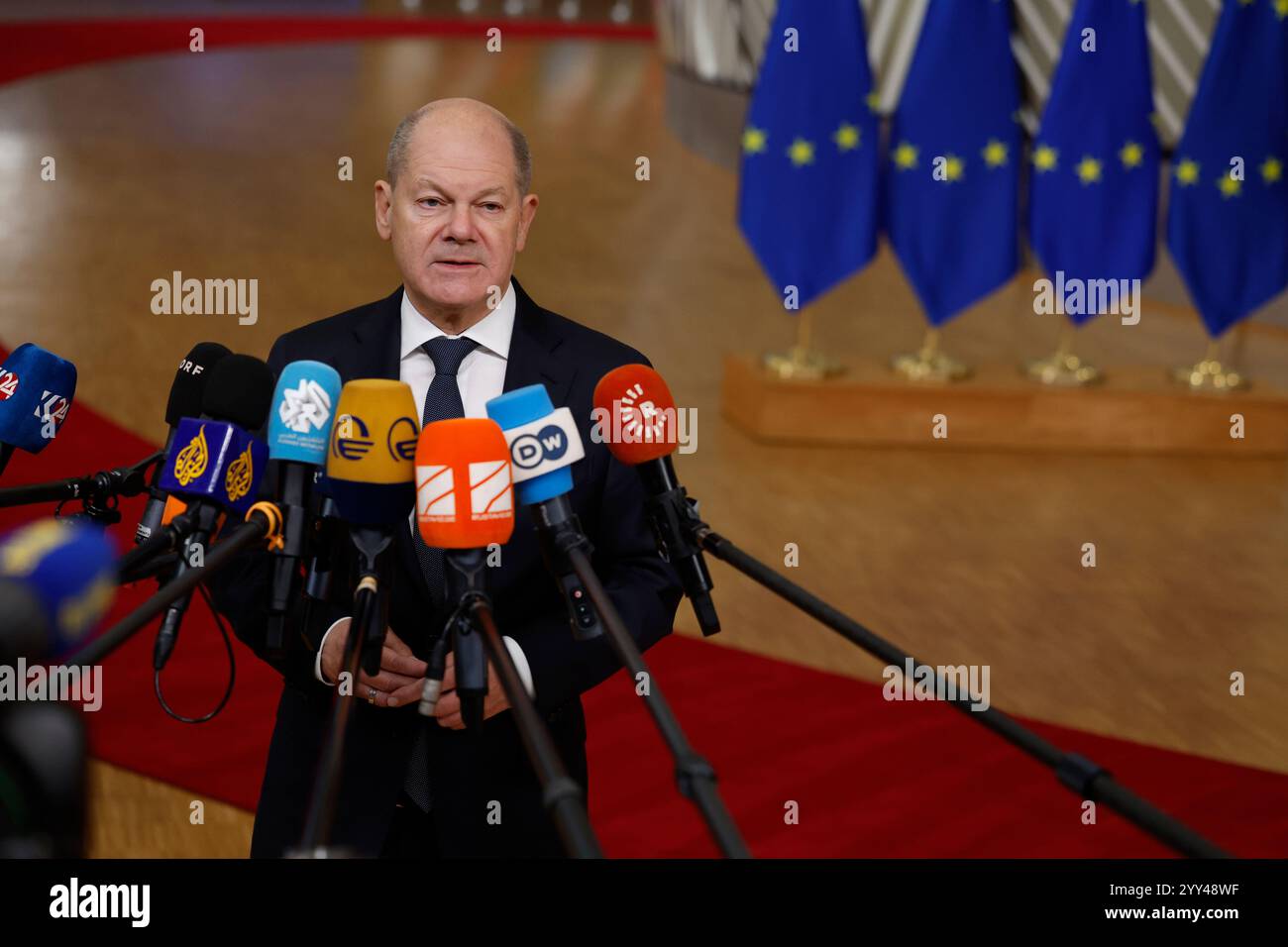 Germany's Chancellor Olaf Scholz speaks with the media as he arrives ...