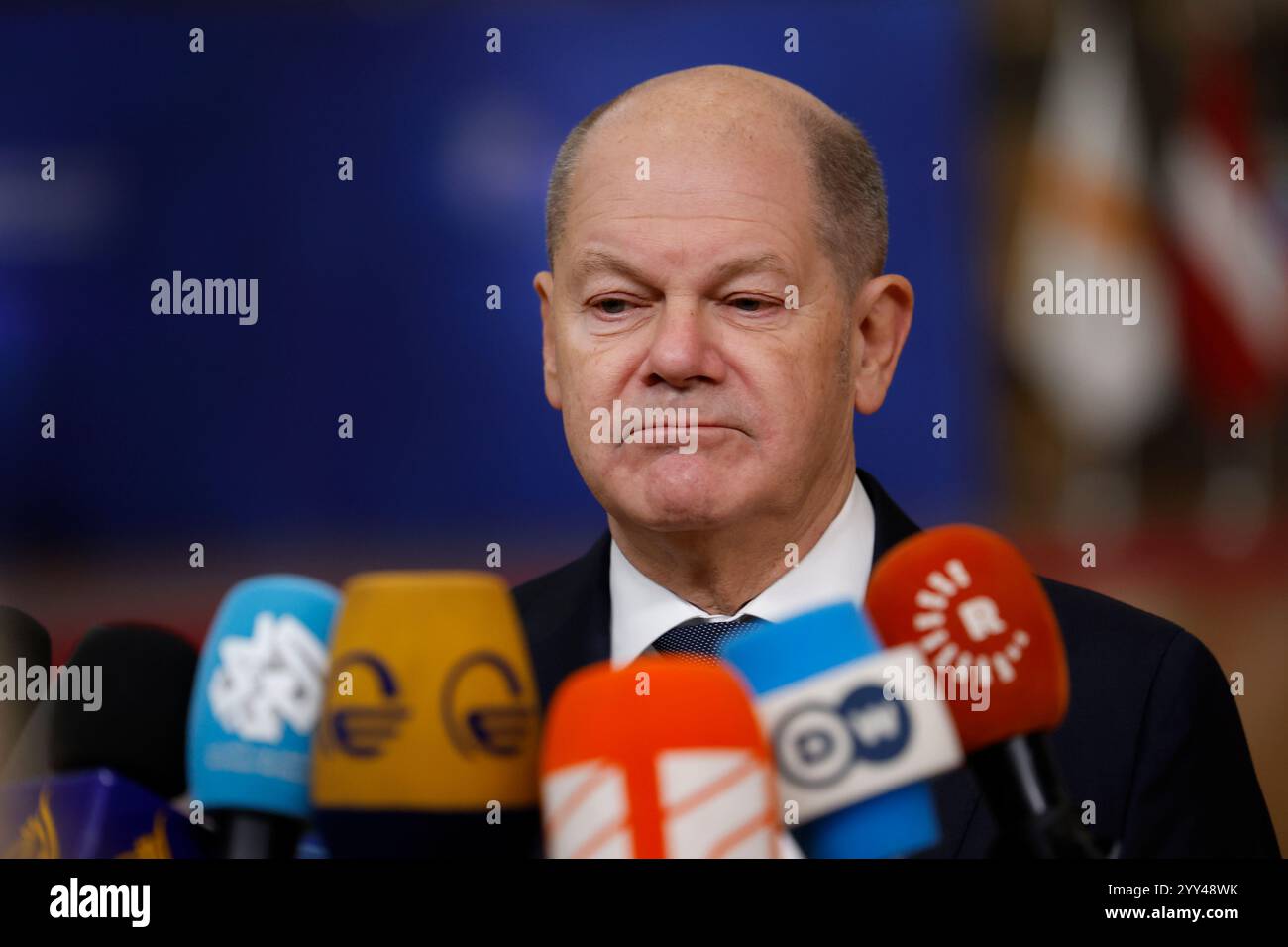 Germany's Chancellor Olaf Scholz speaks with the media as he arrives ...