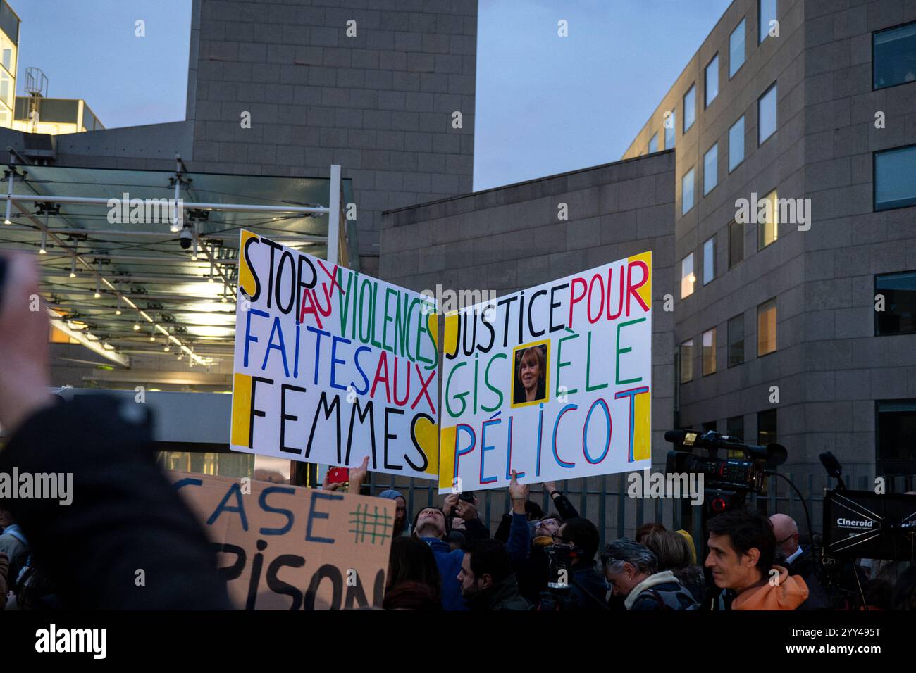 Feminist activists hold up placards as journalists queue to enter the ...