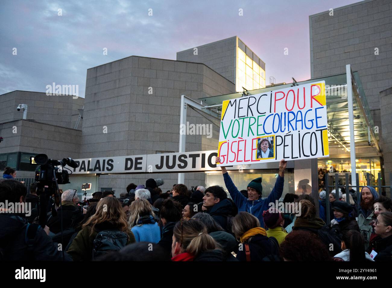 Feminist activists hold up placards as journalists queue to enter the ...