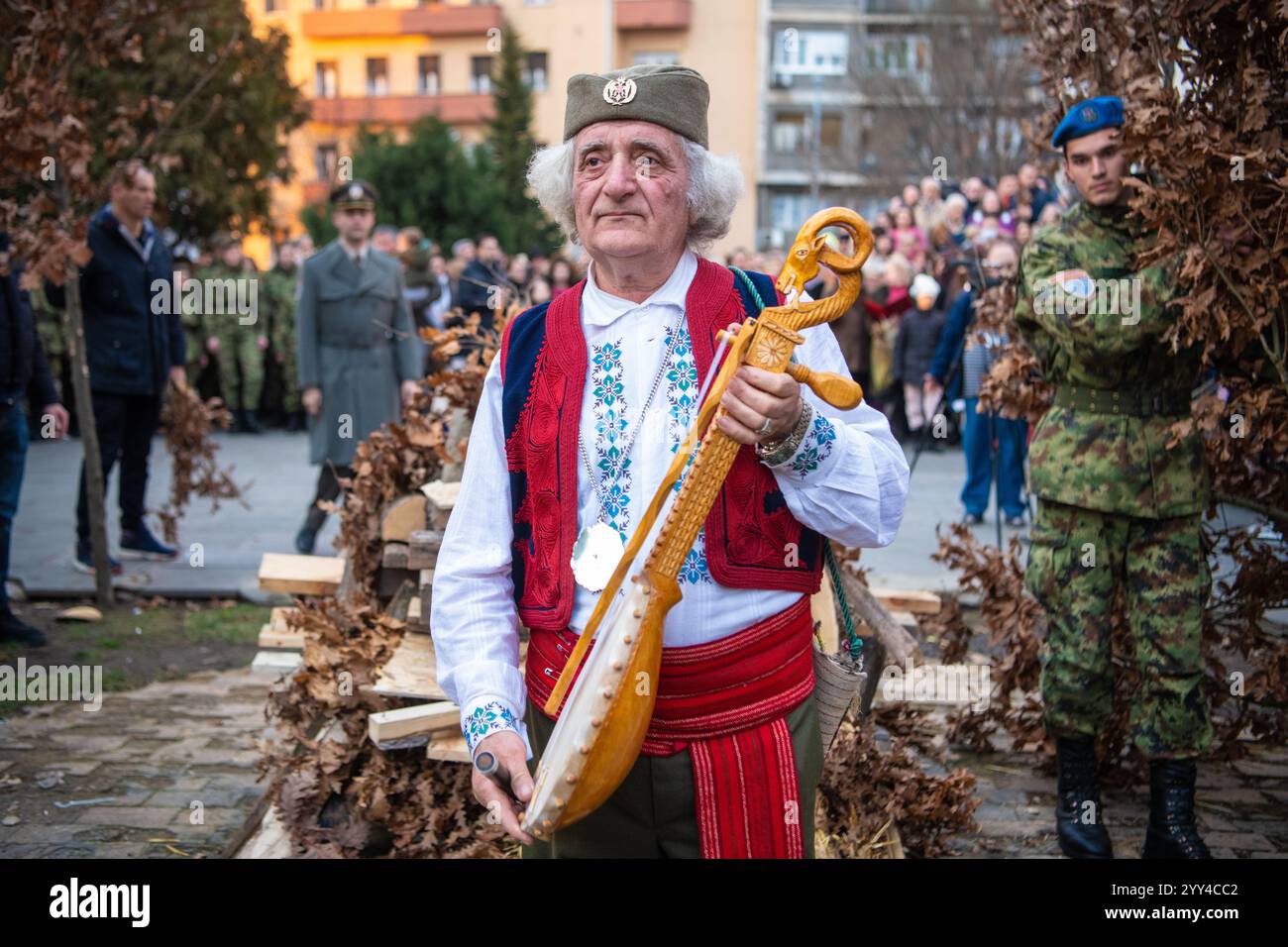 Senior man in Serbian national costume holding fiddle musical ...