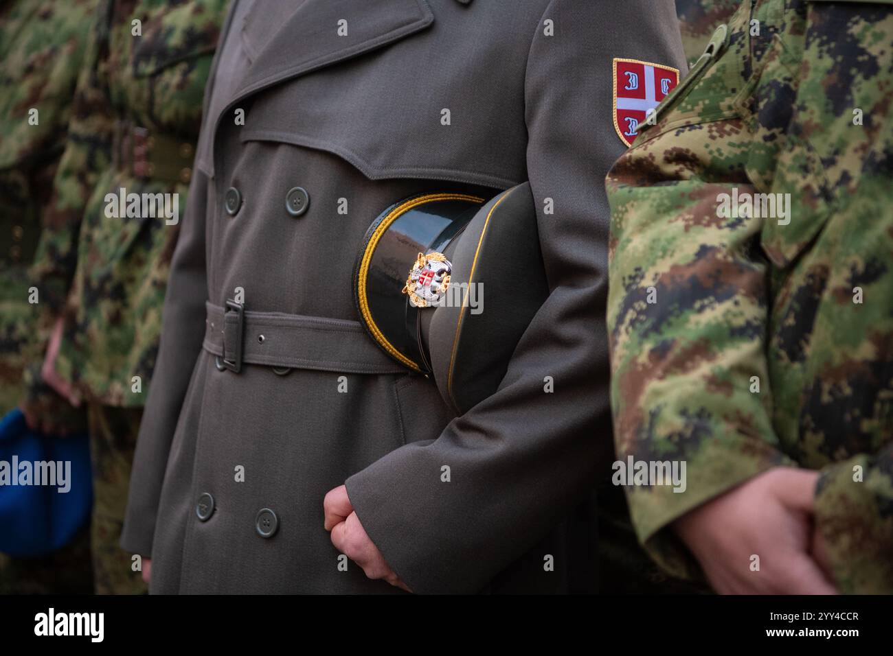 Closeup of Serbia soldier military uniform holding hat in hand. Army, armed forces, soldiers in ...