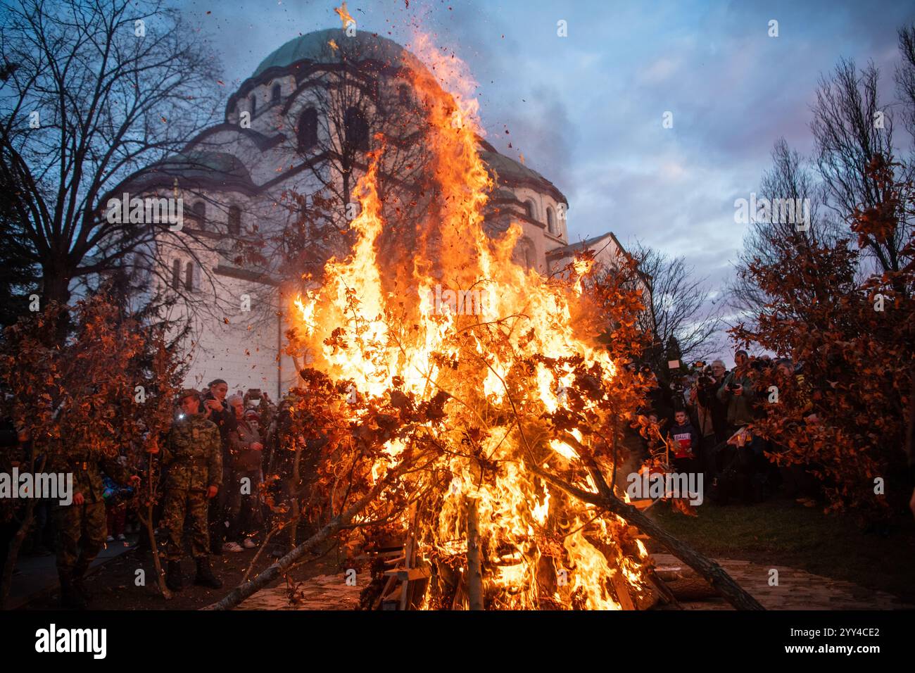 People watch a ceremonial burning of dried oak branches - the Yule log ...