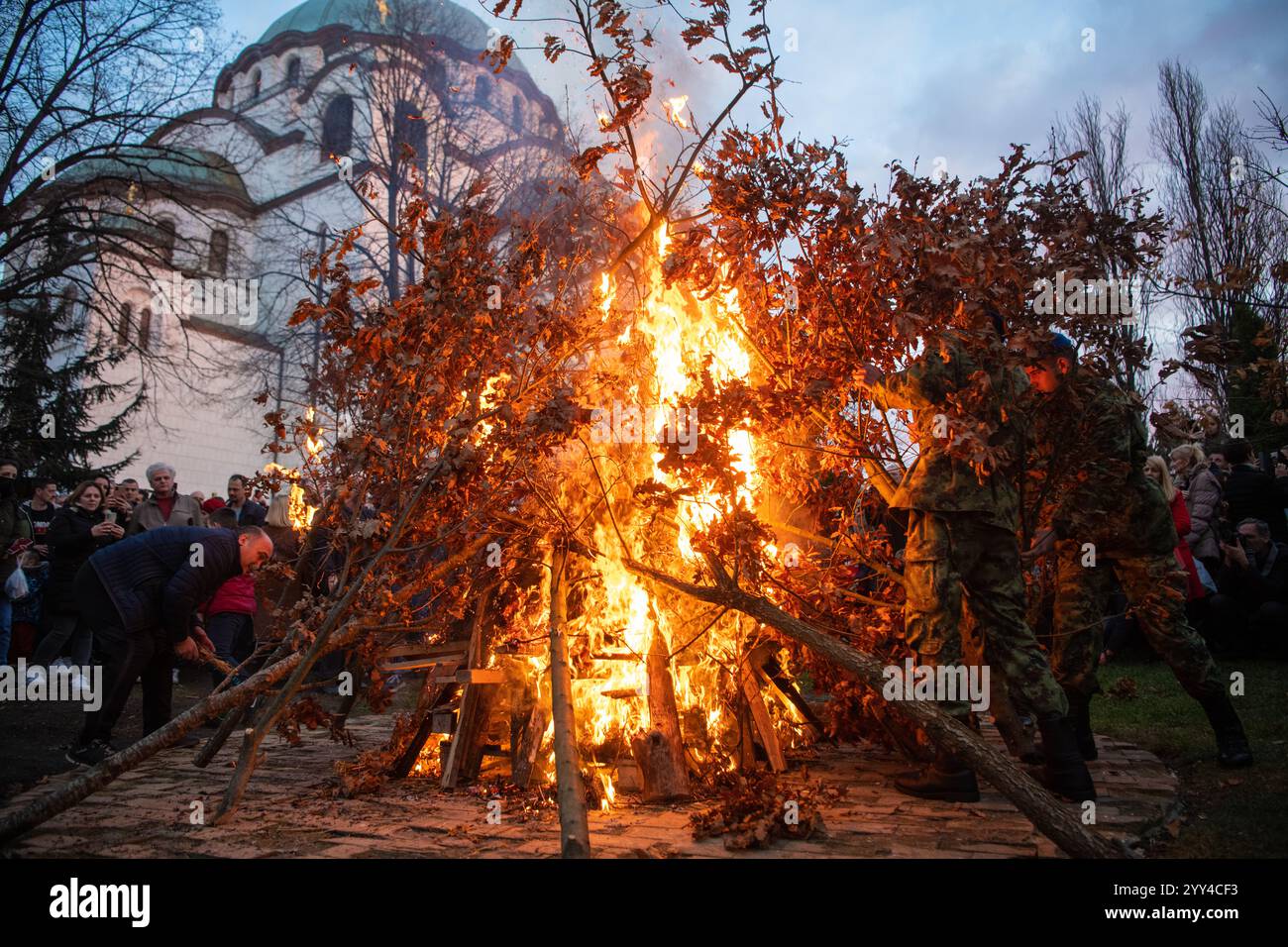 People watch a ceremonial burning of dried oak branches - the Yule log ...