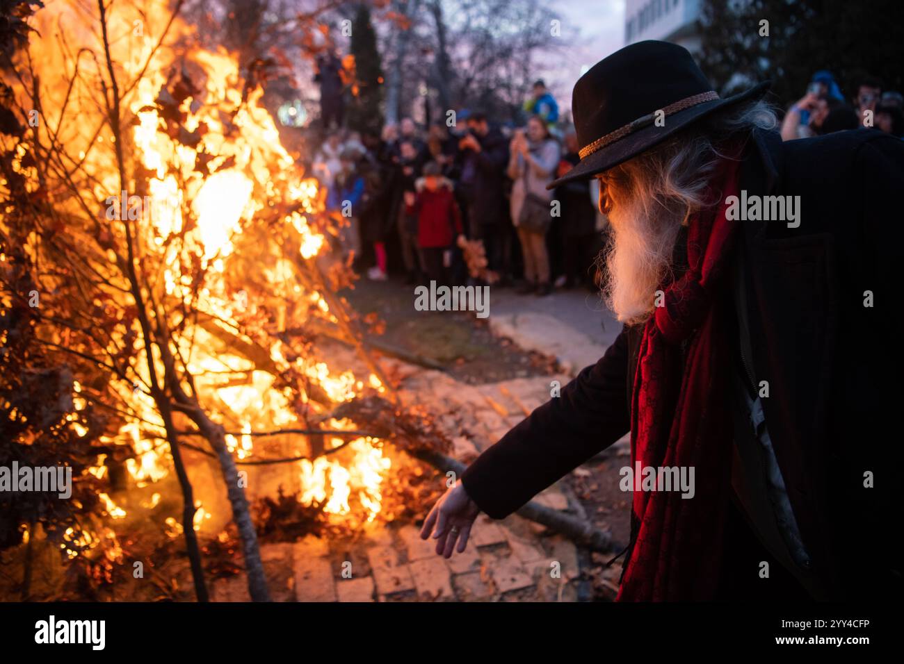 People watch a ceremonial burning of dried oak branches - the Yule log ...