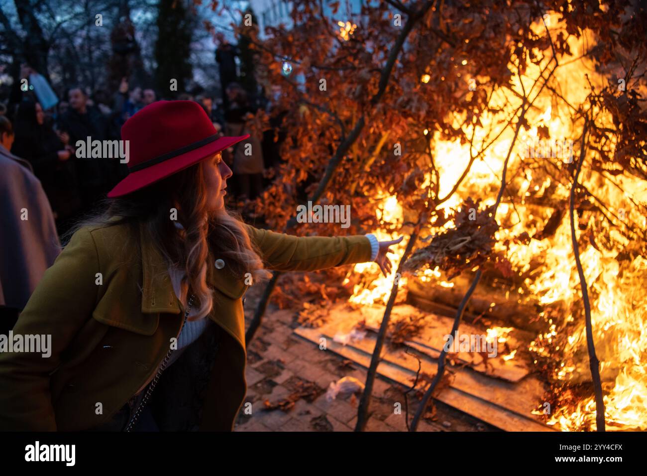 People watch a ceremonial burning of dried oak branches - the Yule log ...