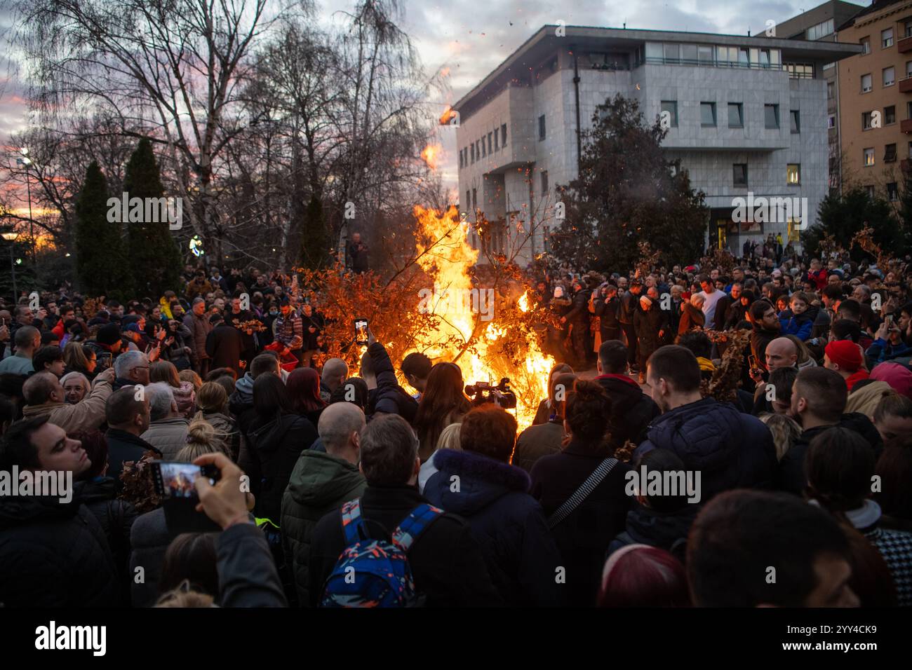 People watch a ceremonial burning of dried oak branches - the Yule log ...